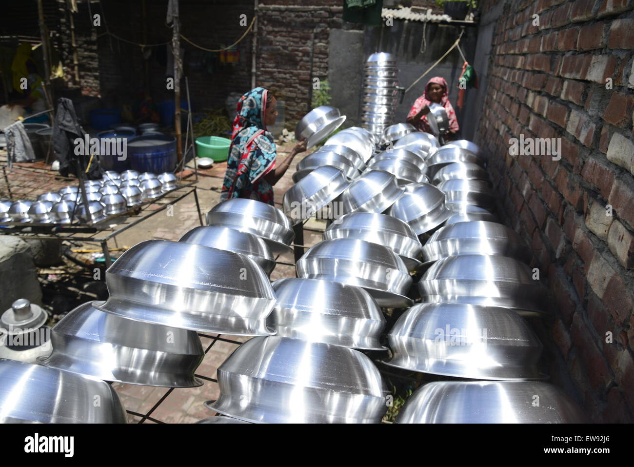 Bangladeshi women labors works in an aluminum pot-making factory, each ...