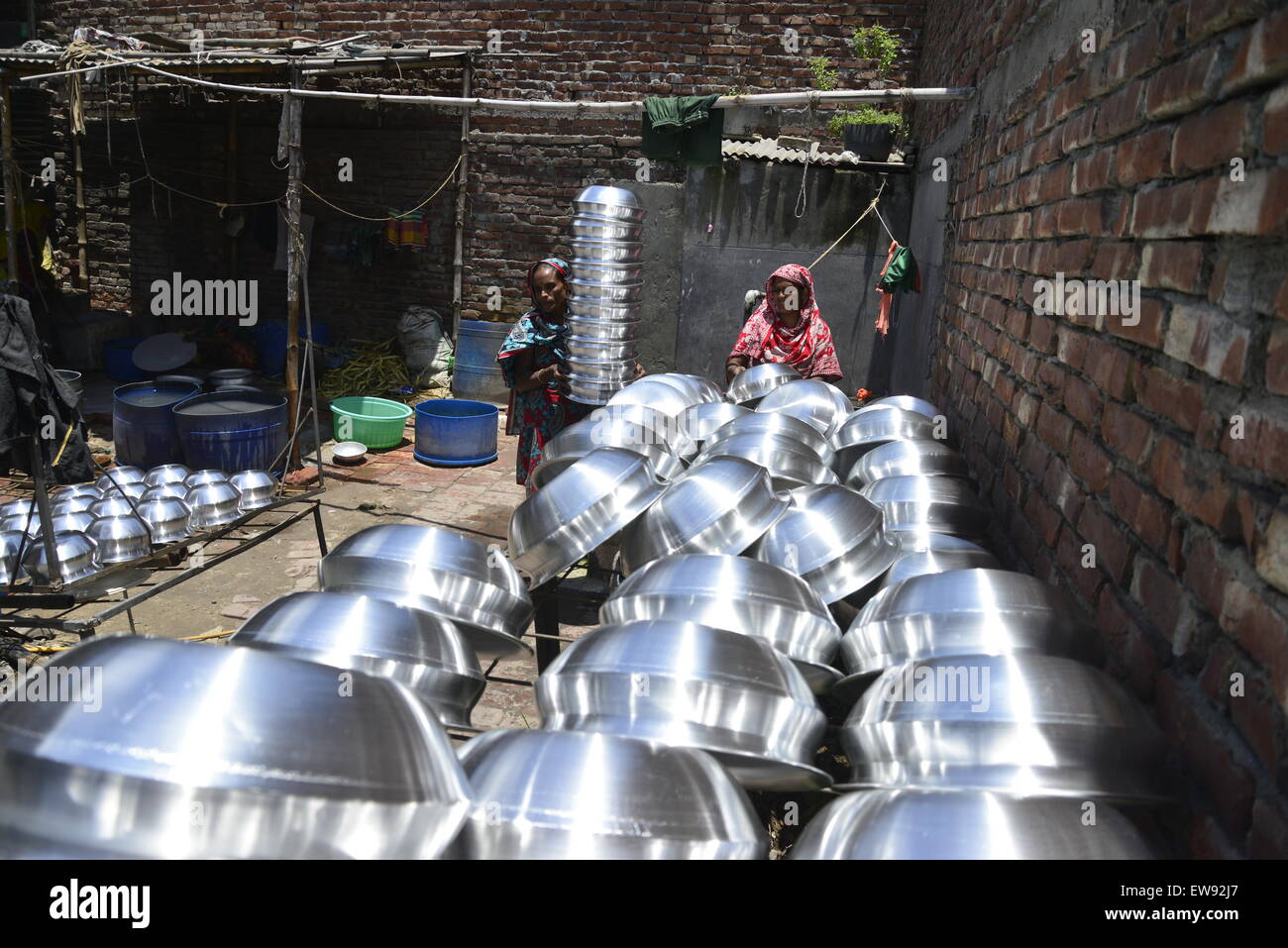 Bangladeshi women labors works in an aluminum pot-making factory, each ...