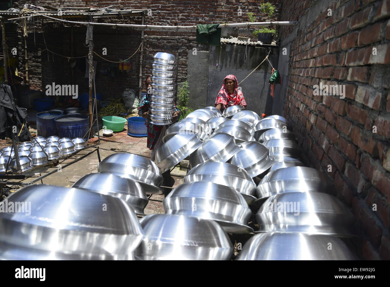 Bangladeshi women labors works in an aluminum pot-making factory, each ...