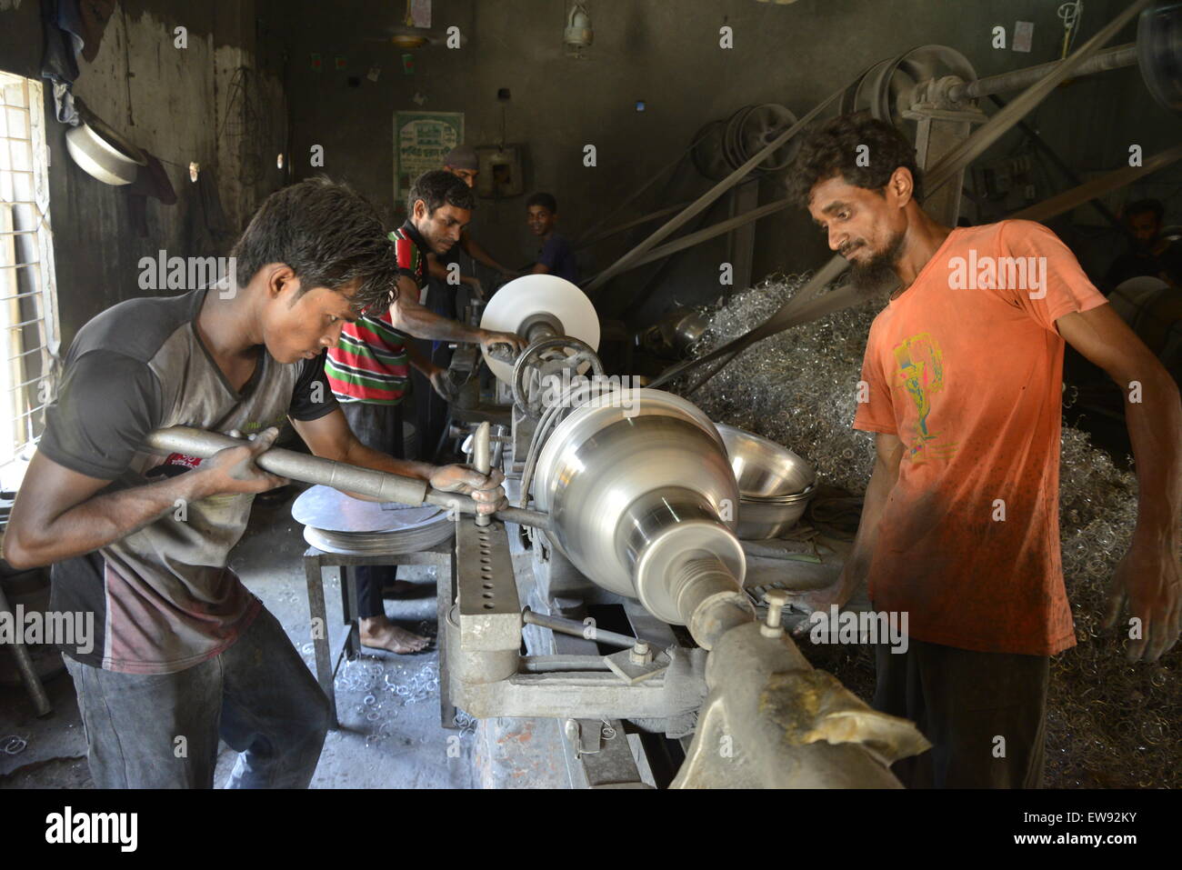 Bangladeshi manual labors works in an aluminum pot-making factory, each ...