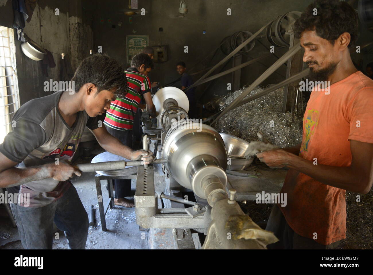 Bangladeshi manual labors works in an aluminum pot-making factory, each ...