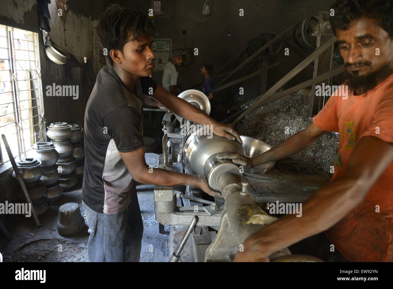 Bangladeshi manual labors works in an aluminum pot-making factory, each ...