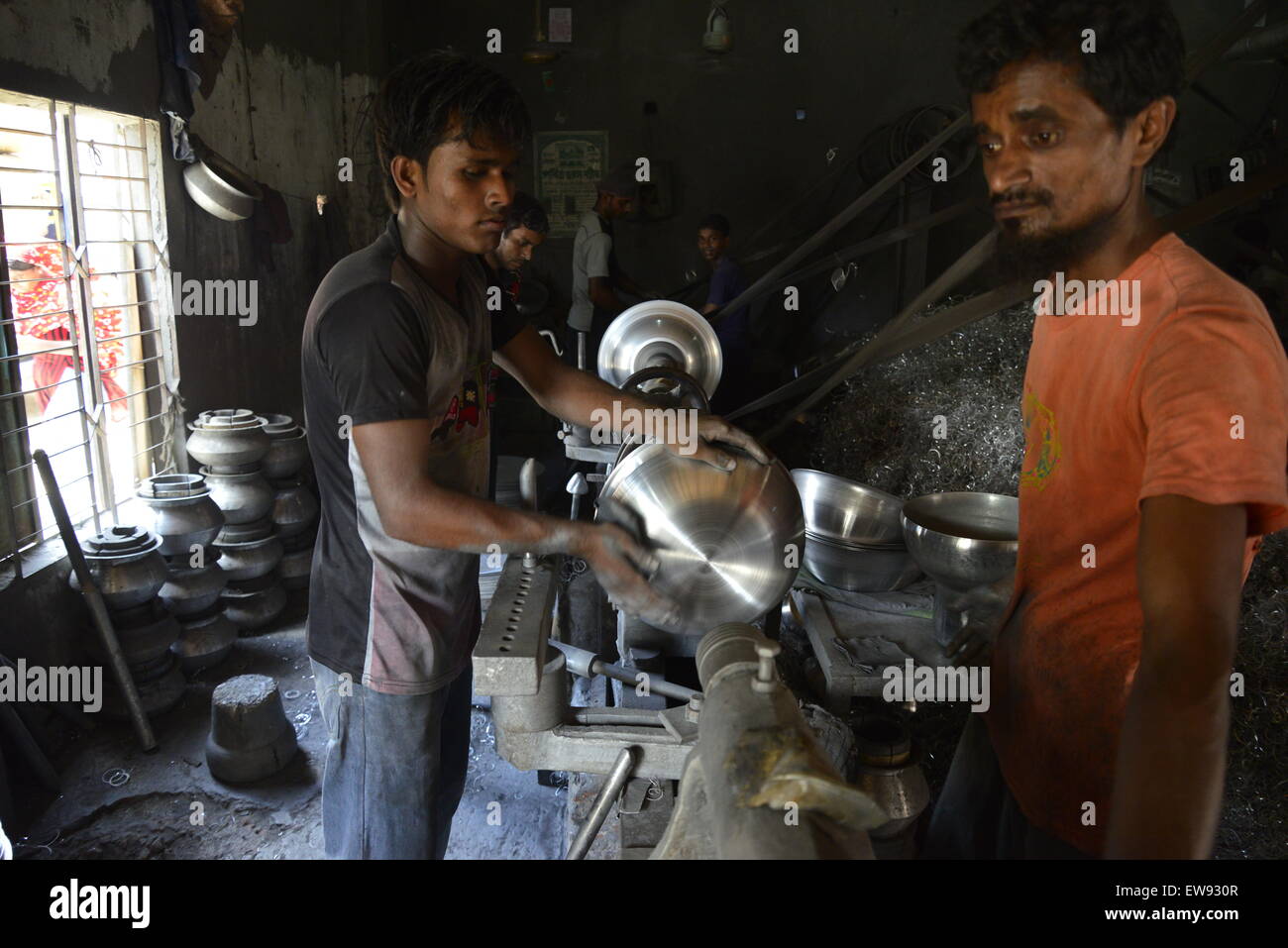 Bangladeshi manual labors works in an aluminum pot-making factory, each ...