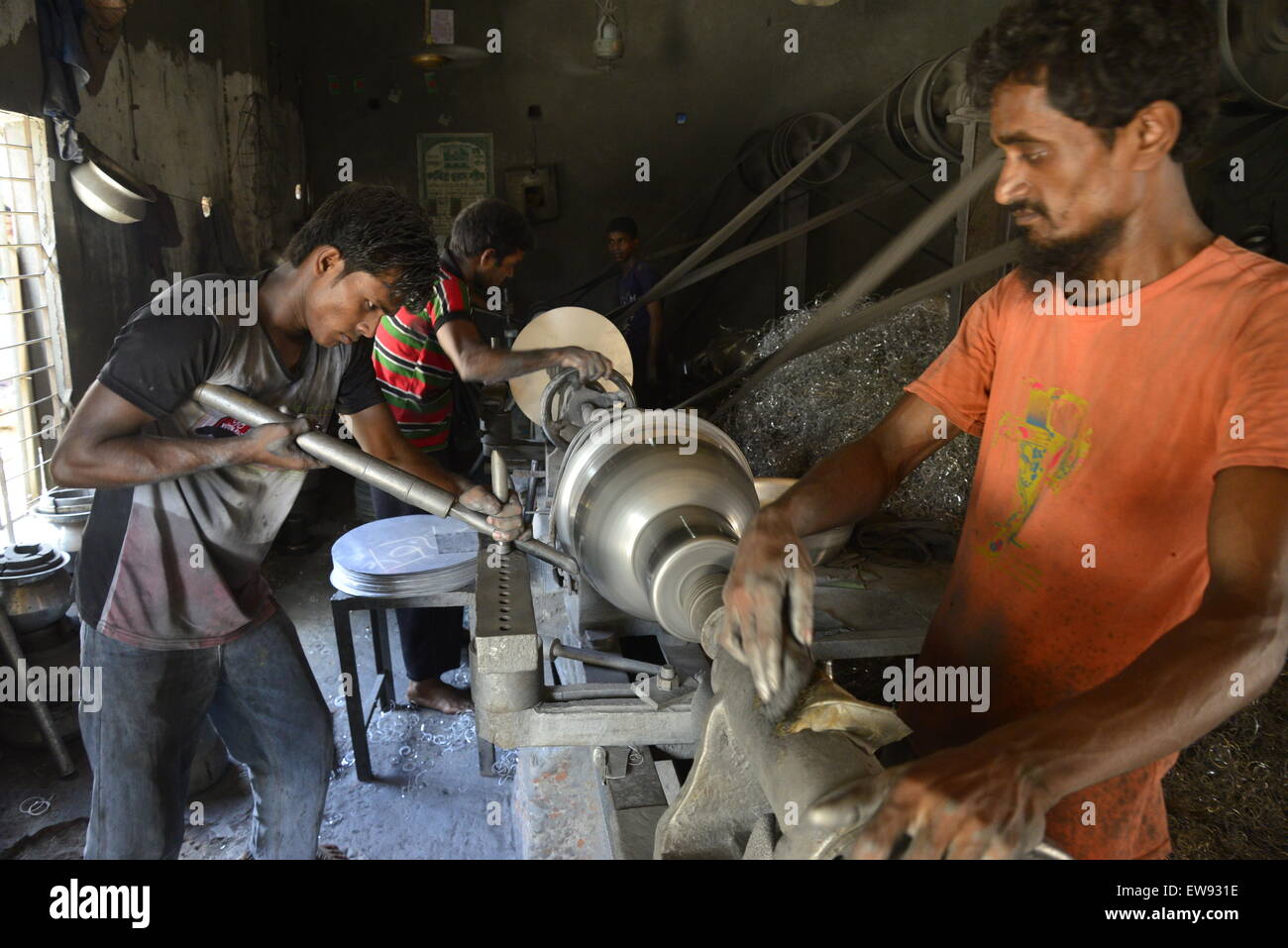 Bangladeshi manual labors works in an aluminum pot-making factory, each ...