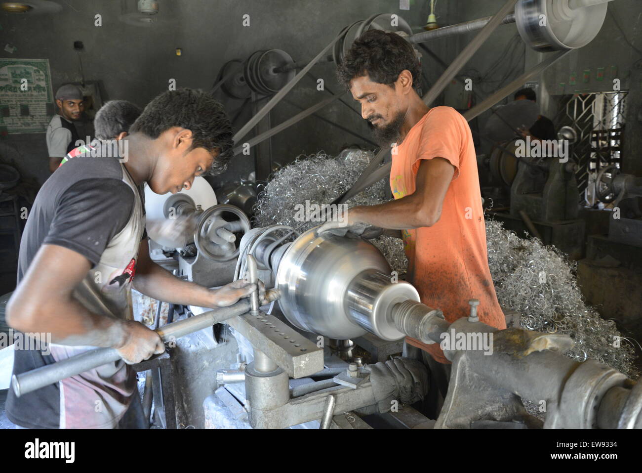 Bangladeshi manual labors works in an aluminum pot-making factory, each ...