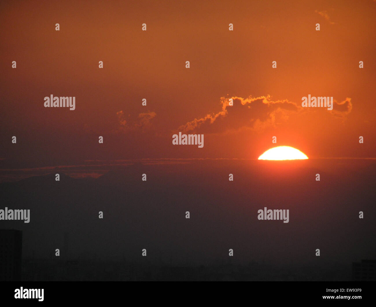 A breathtaking sunset over Tokyo on October 2, 2003, casting warm hues ...