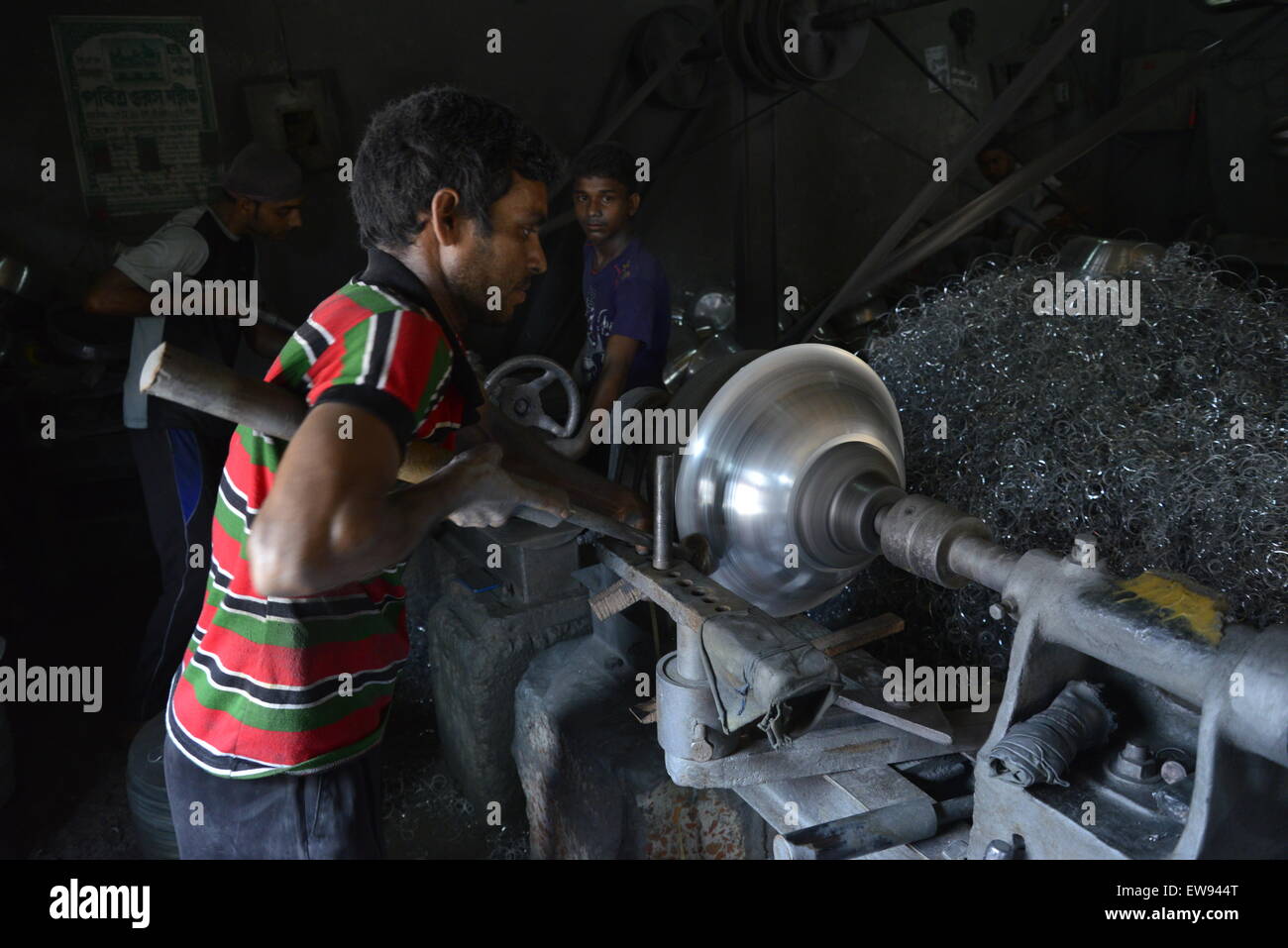 Bangladeshi manual labors works in an aluminum pot-making factory, each ...