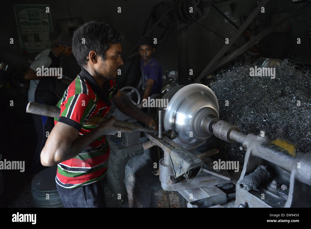 Bangladeshi manual labors works in an aluminum pot-making factory, each ...