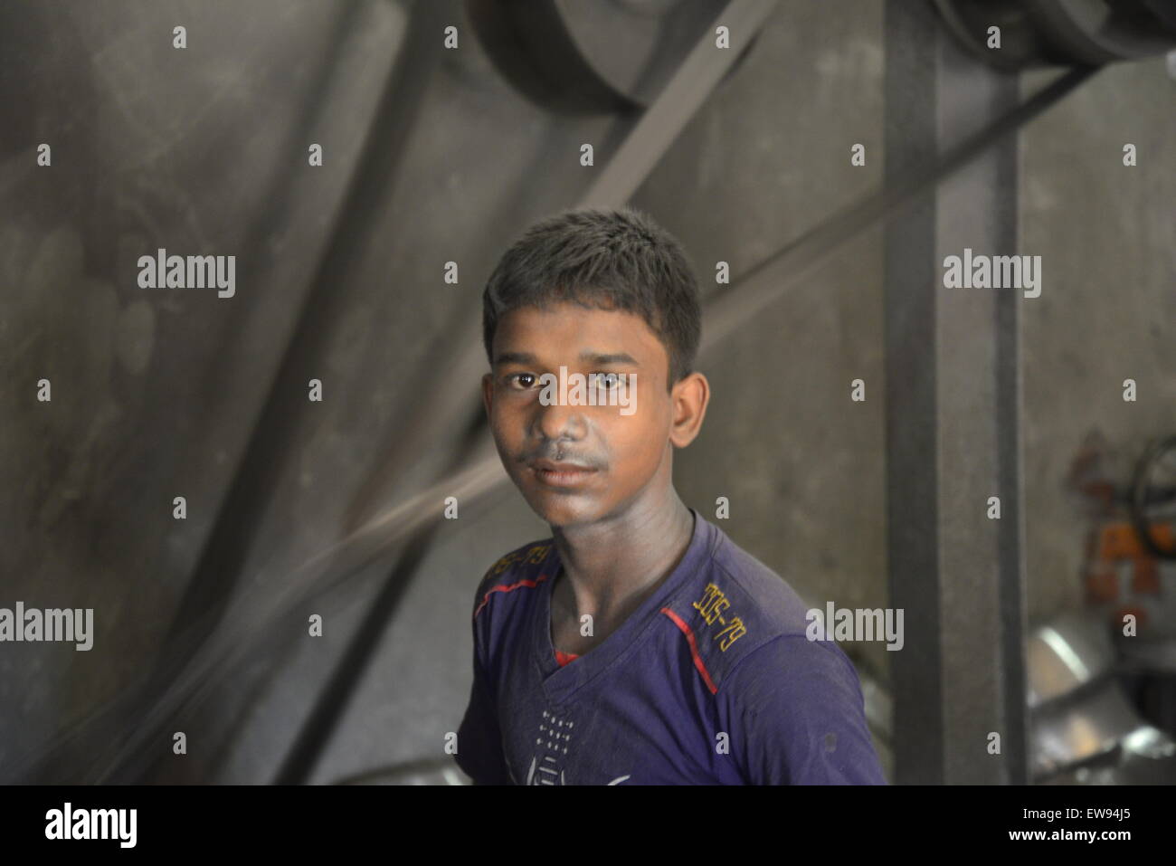 A portrait of Child labor, who works in an aluminum pot-making factory ...