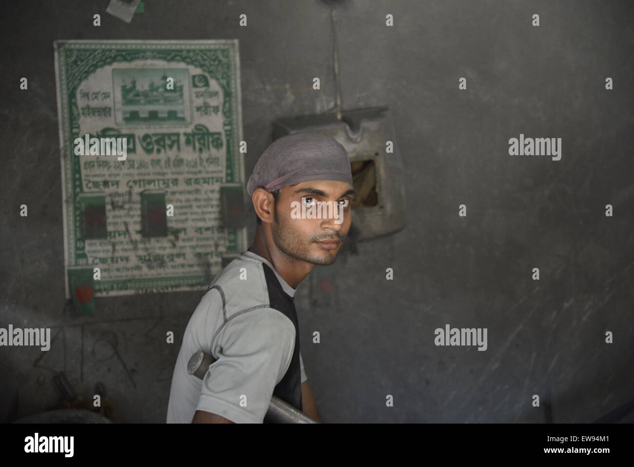 A portrait of manual labor, who works in an aluminum pot-making factory ...