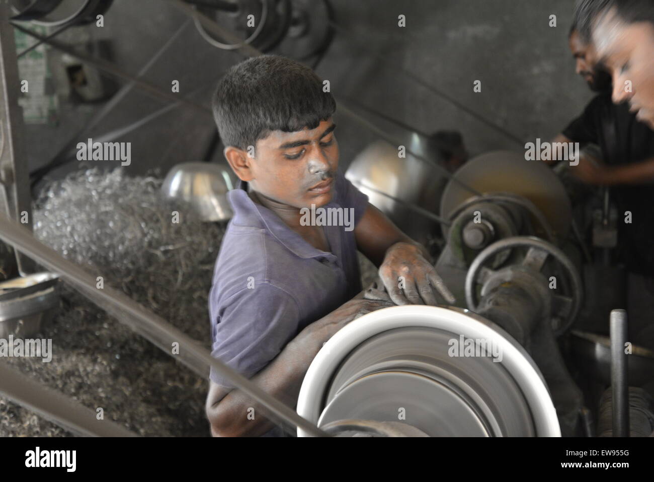 Bangladeshi manual labors works in an aluminum pot-making factory, each ...