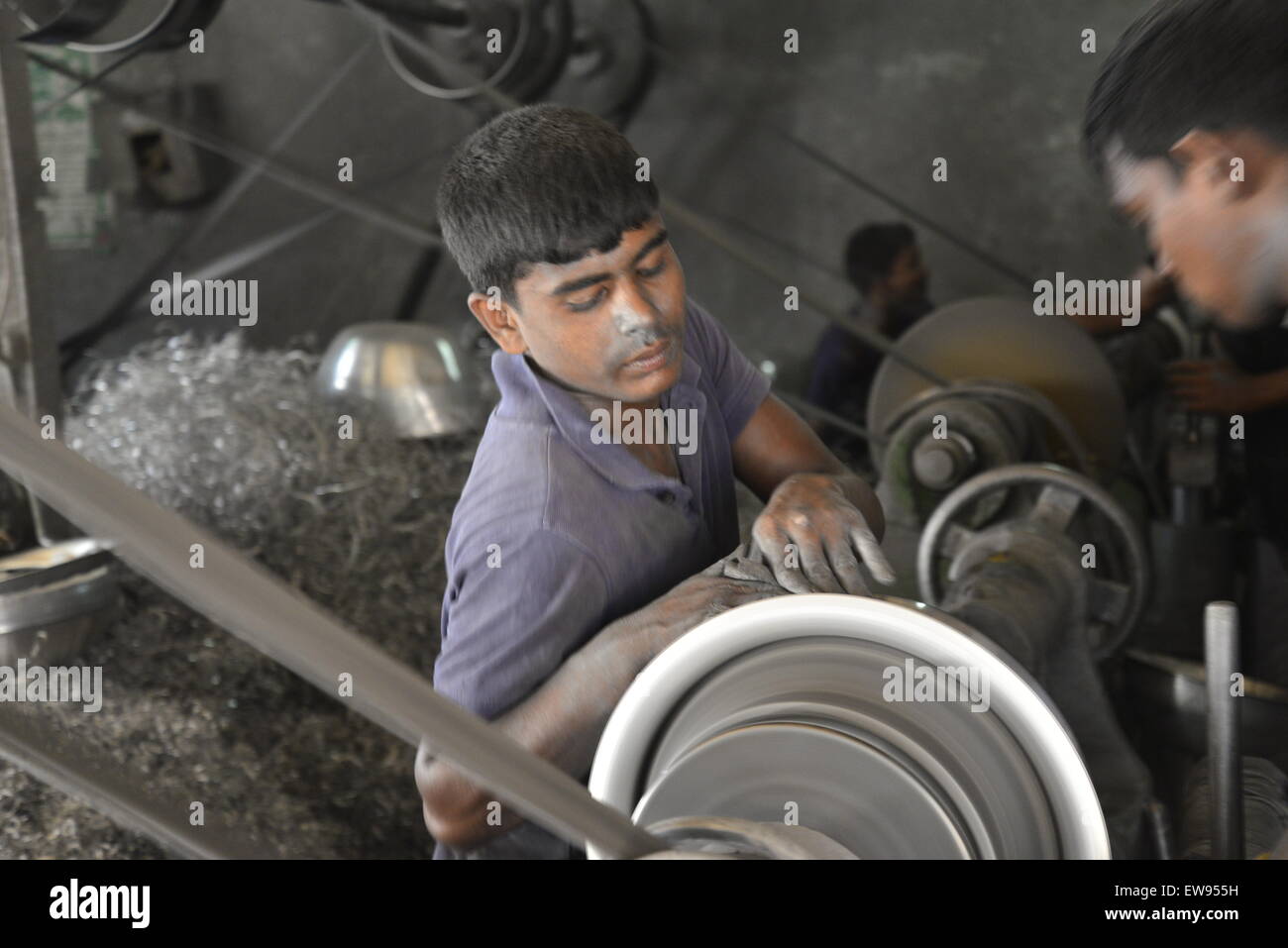 Bangladeshi manual labors works in an aluminum pot-making factory, each ...