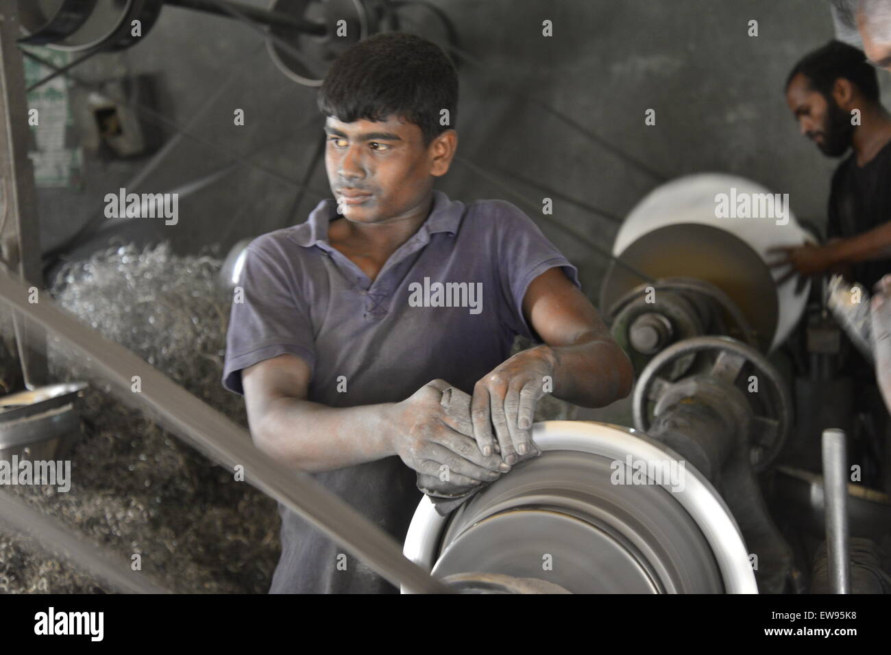 Bangladeshi manual labors works in an aluminum pot-making factory, each ...
