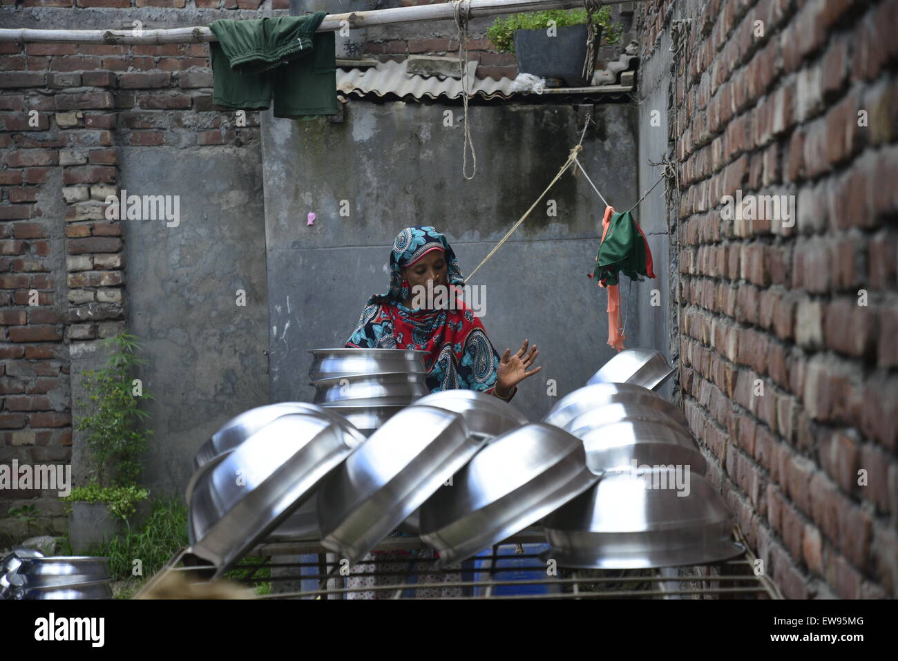 Bangladeshi manual women labors works in an aluminum pot-making factory ...