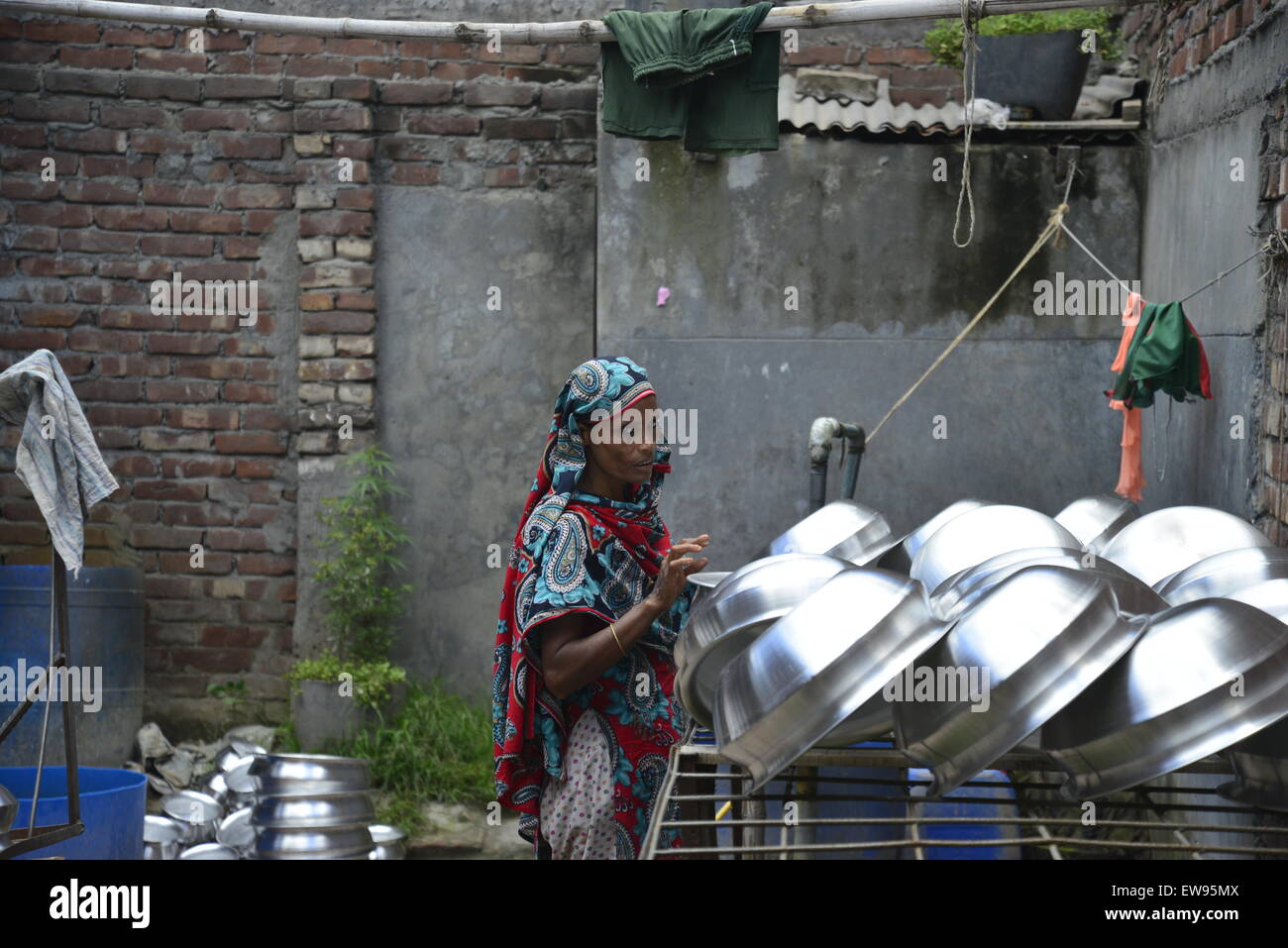 Bangladeshi manual women labors works in an aluminum pot-making factory ...