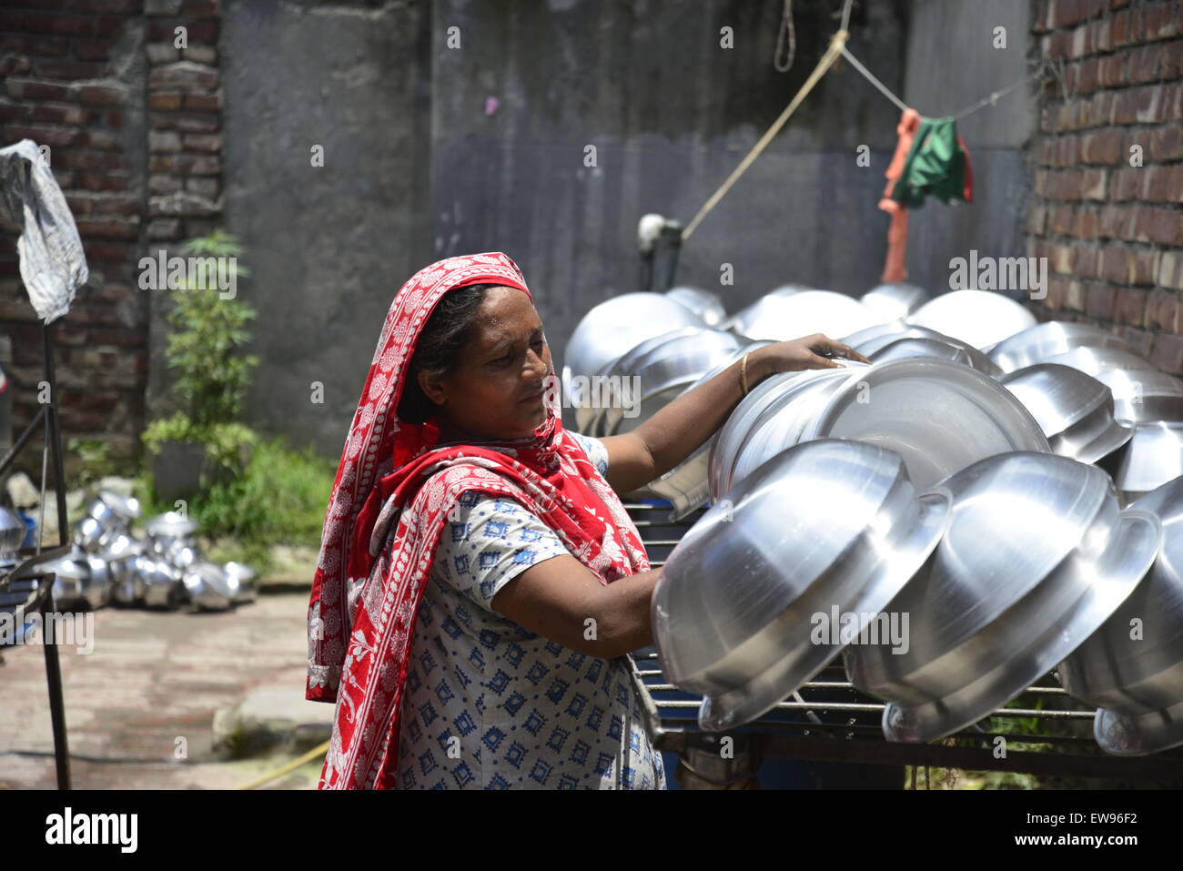 Bangladeshi manual women labors works in an aluminum pot-making factory ...