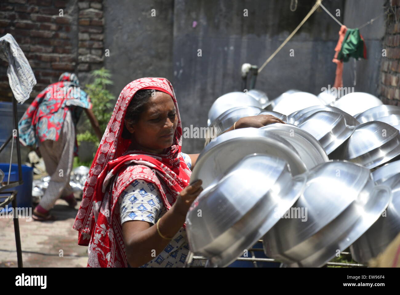 Bangladeshi manual women labors works in an aluminum pot-making factory ...