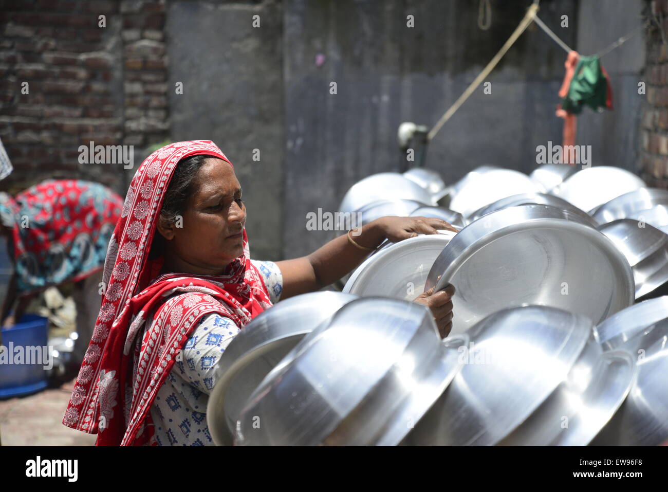 Bangladeshi manual women labors works in an aluminum pot-making factory ...