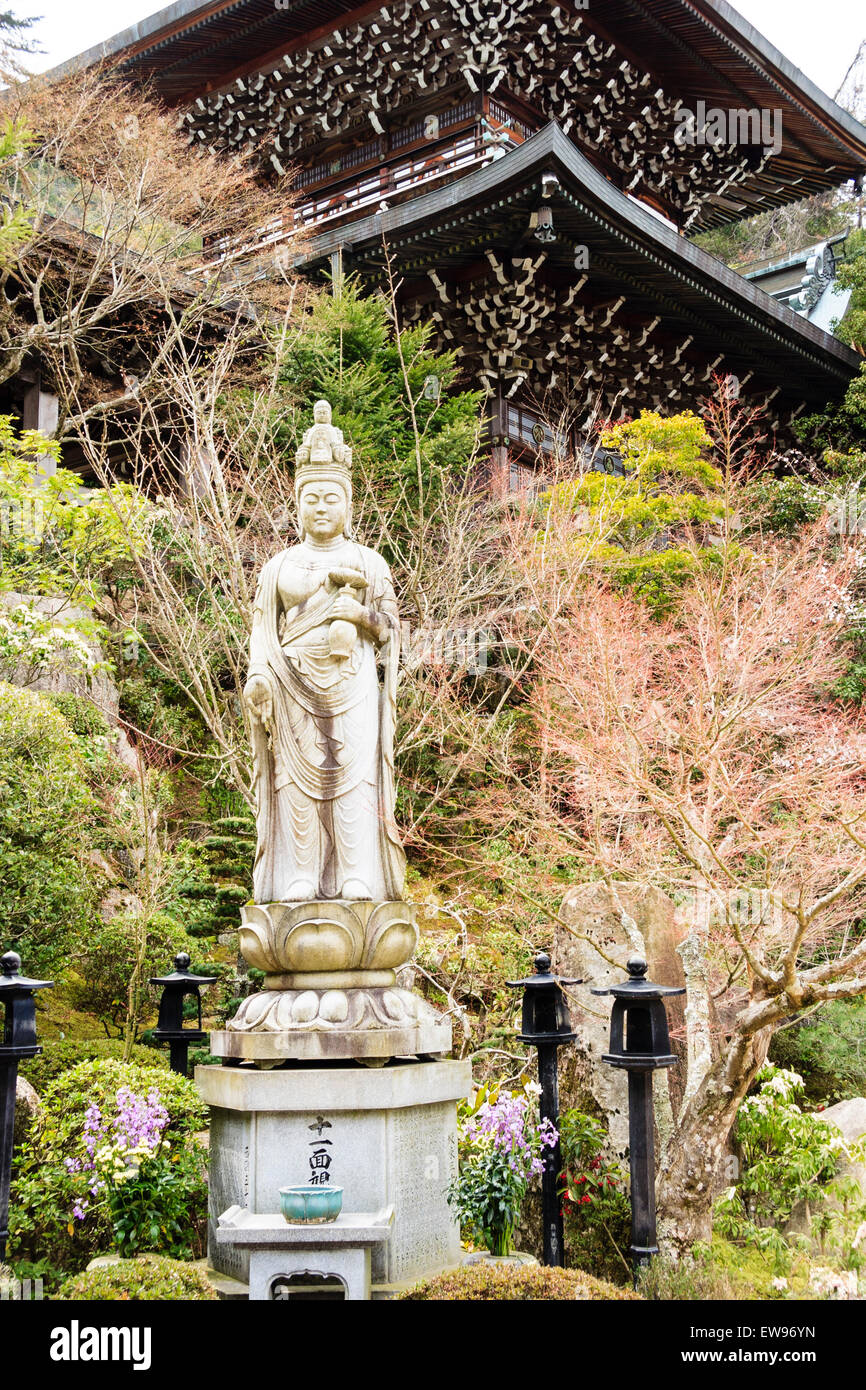 Japan, Miyajima, Daisho-in temple. Bosatsu Kannon statue on a pedestal ...