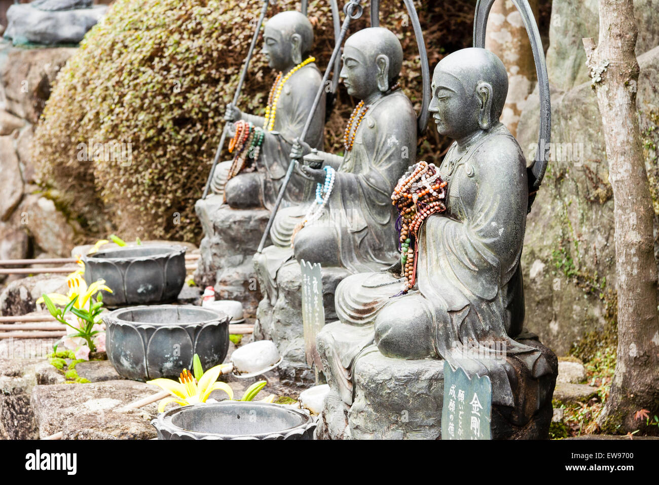Japan, Miyajima. Daisho-in temple. Line of three Jizo Bosatsu stone ...