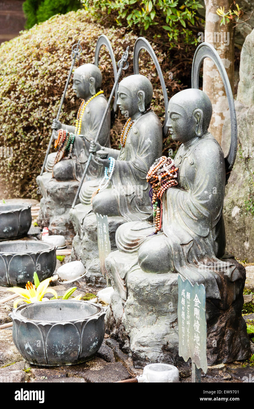 Japan, Miyajima. Daisho-in temple. Line of three Jizo Bosatsu stone ...