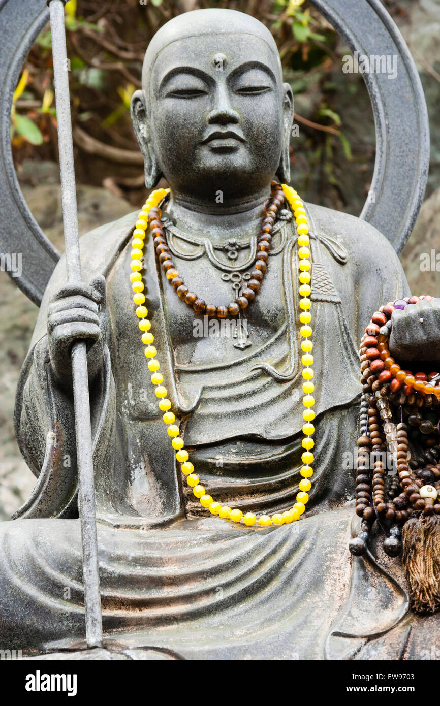 Japan, Miyajima. Daisho-in temple. Close up of a Jizo Bosatsu stone ...