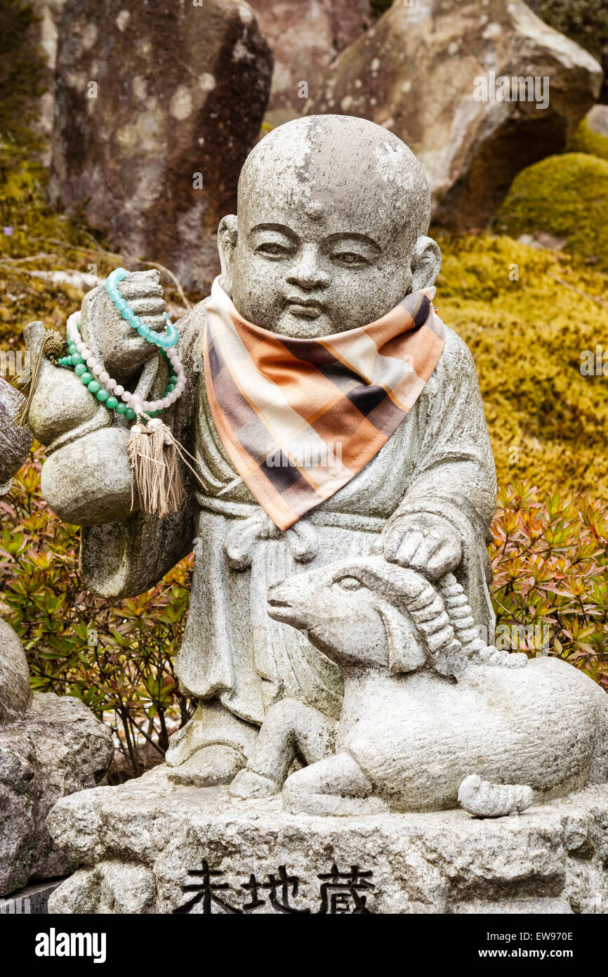 Japan, Miyajima. Daisho-in temple. Small Jizo statue of a standing ...