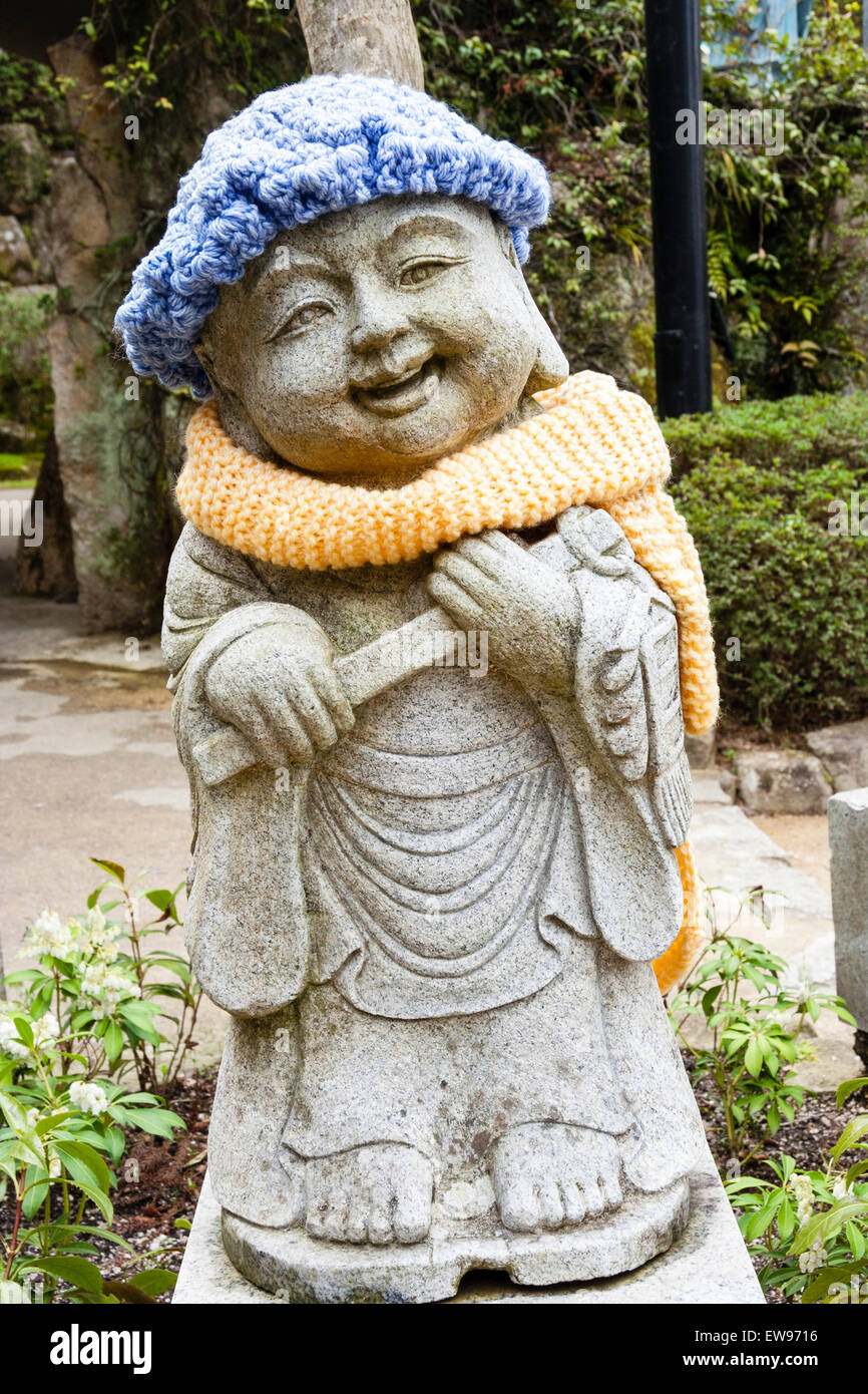 Japan, Miyajima. Daisho-in. Stone Jizo statue of standing Buddhist monk ...