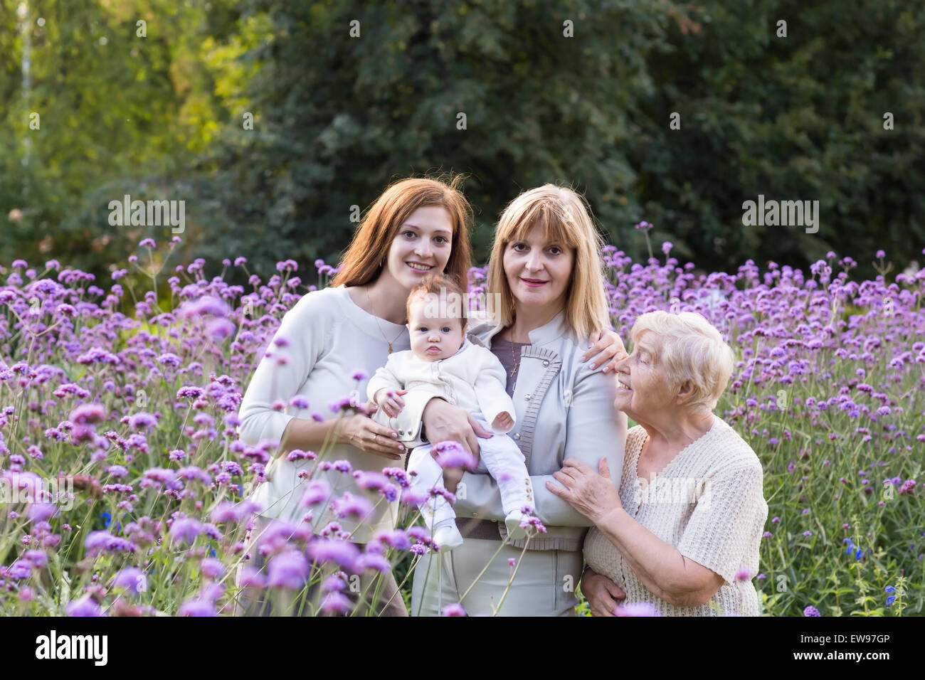 Four generations of beautiful women standing in a colorful lavender ...