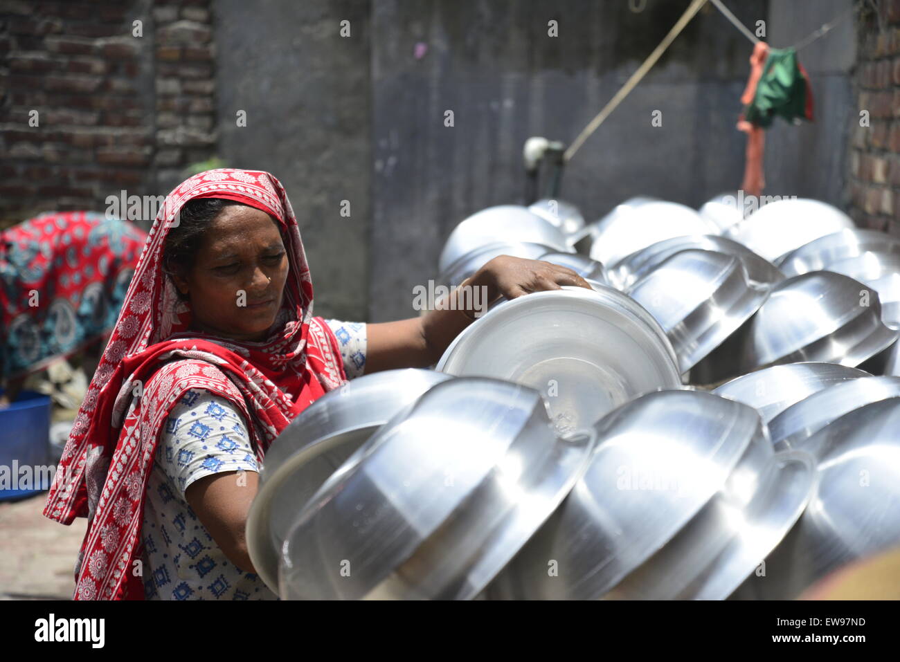 Bangladeshi manual women labors works in an aluminum pot-making factory ...