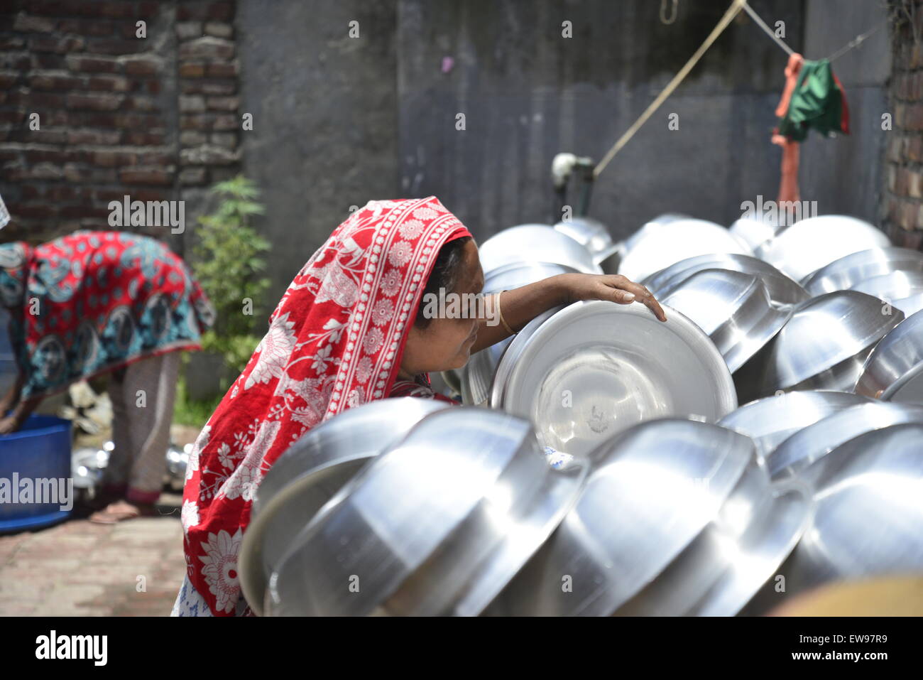 Bangladeshi manual women labors works in an aluminum pot-making factory ...