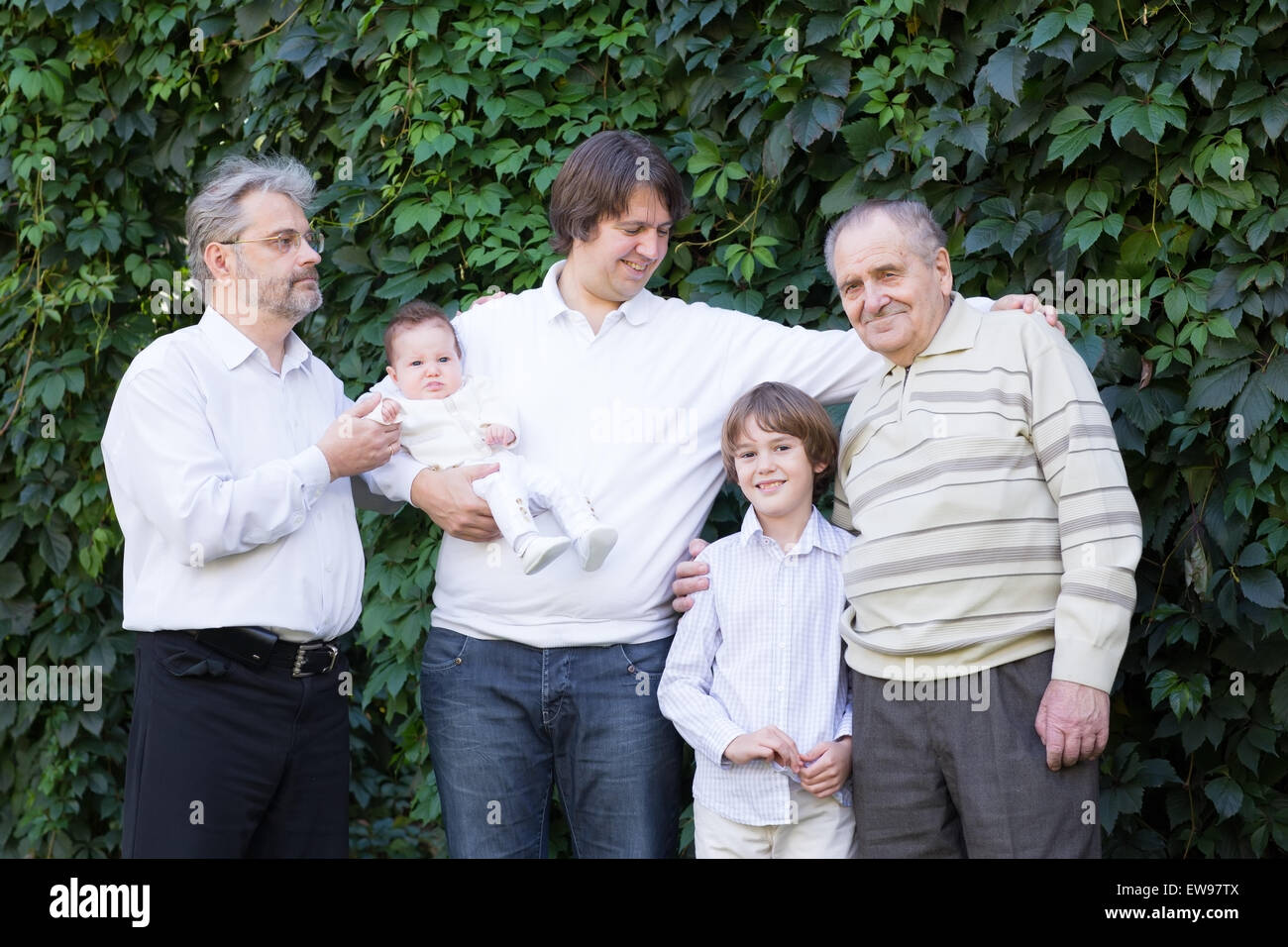 Four generations of men and a baby girl in a park Stock Photo - Alamy