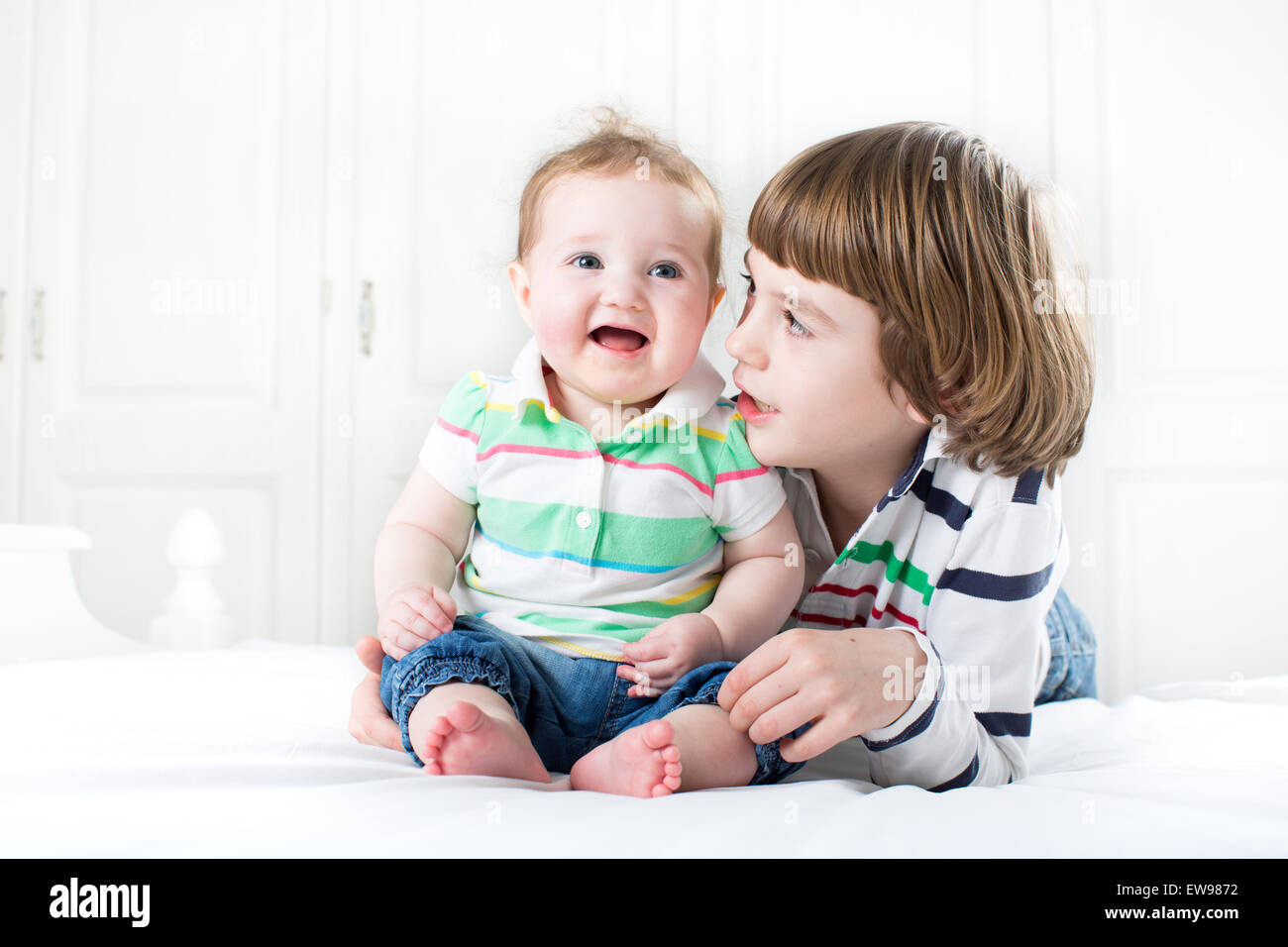 Cute boy talking to his baby sister Stock Photo - Alamy