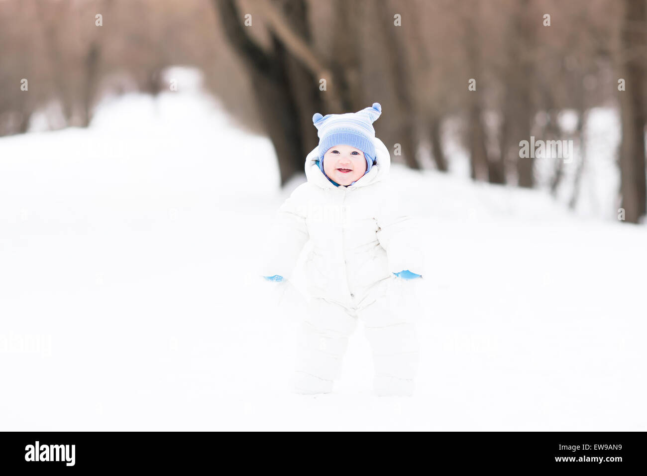 Baby's first steps in the snow Stock Photo - Alamy