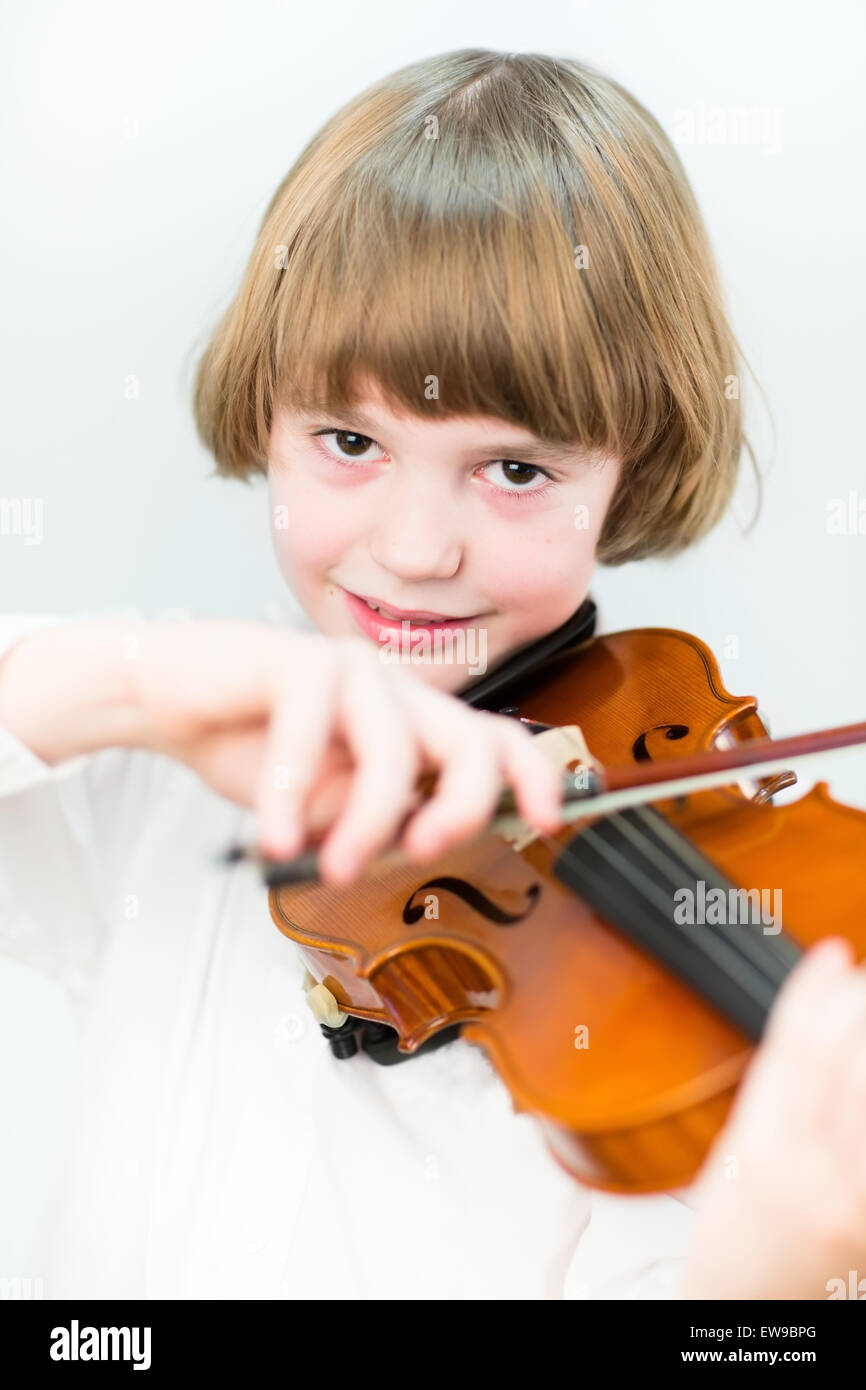 Happy child playing violin Stock Photo - Alamy