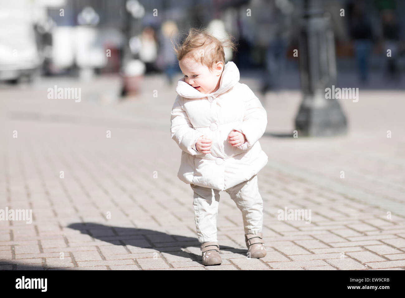 Beautiful little girl walking in the sun Stock Photo - Alamy