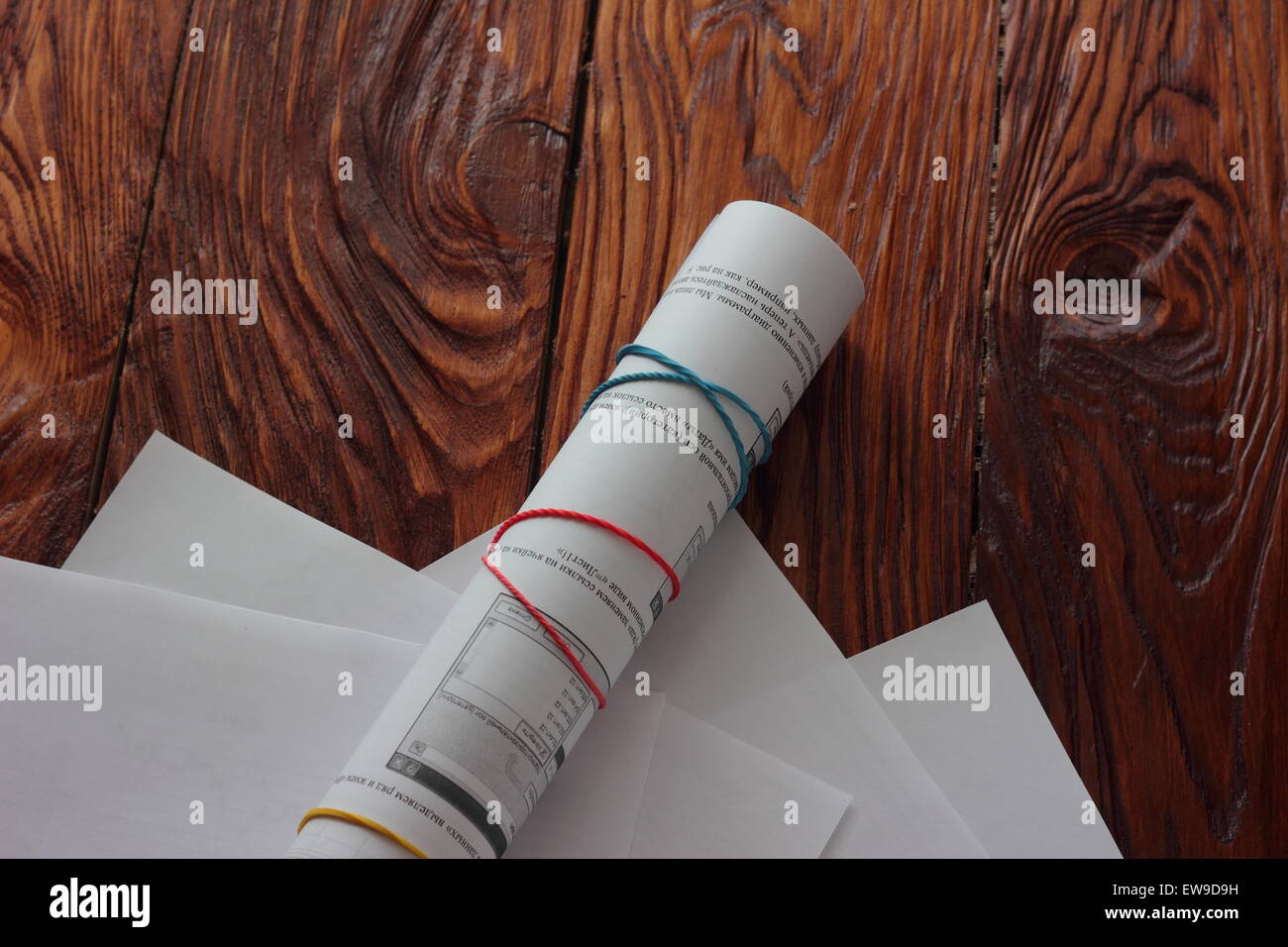 lying financial papers rolled into a tube with rubber bands Stock Photo ...