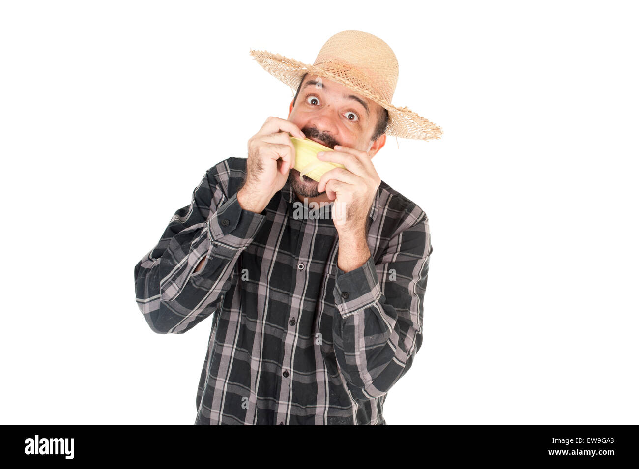 Man eating corn in saint john holiday Stock Photo - Alamy