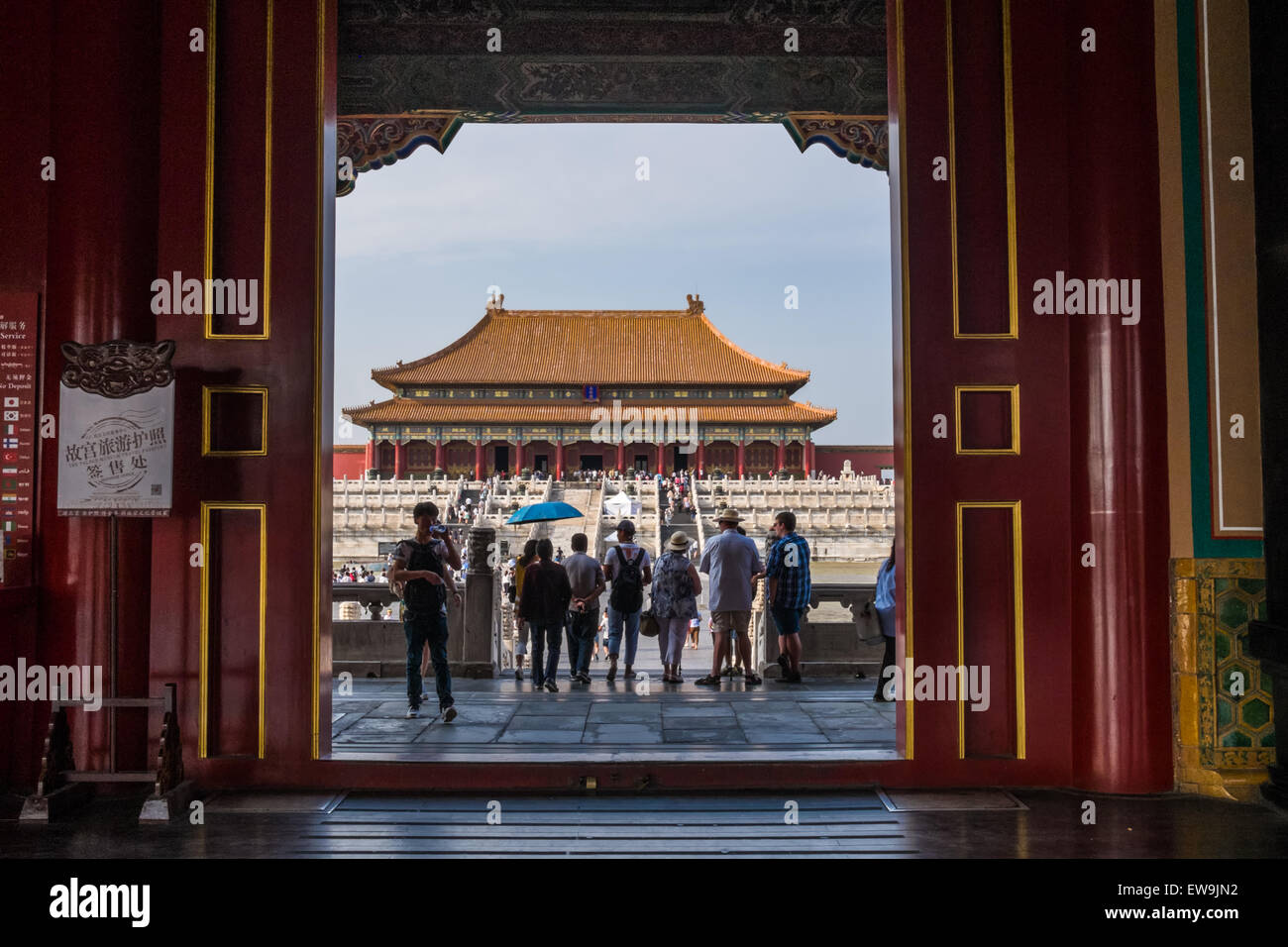 Tourists viewing hall seen through a door Stock Photo - Alamy
