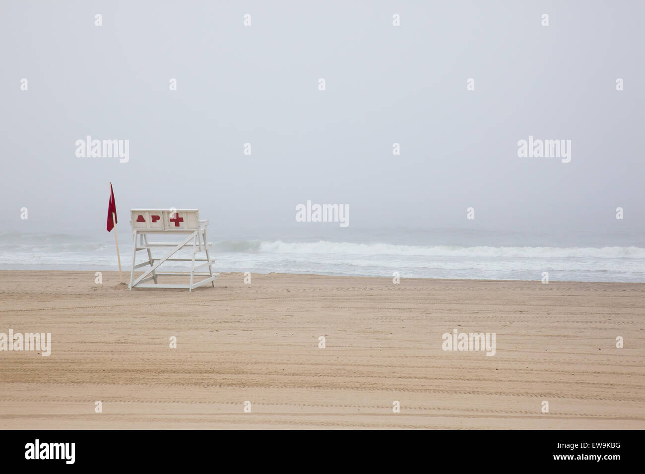 Empty life guard chair on a beach on a hazy day Stock Photo - Alamy