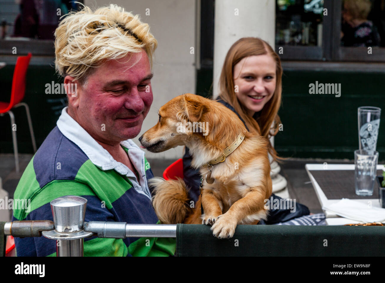 A Man Sits Outside A Bar With His Pet Dog, Brighton, Sussex, UK Stock ...