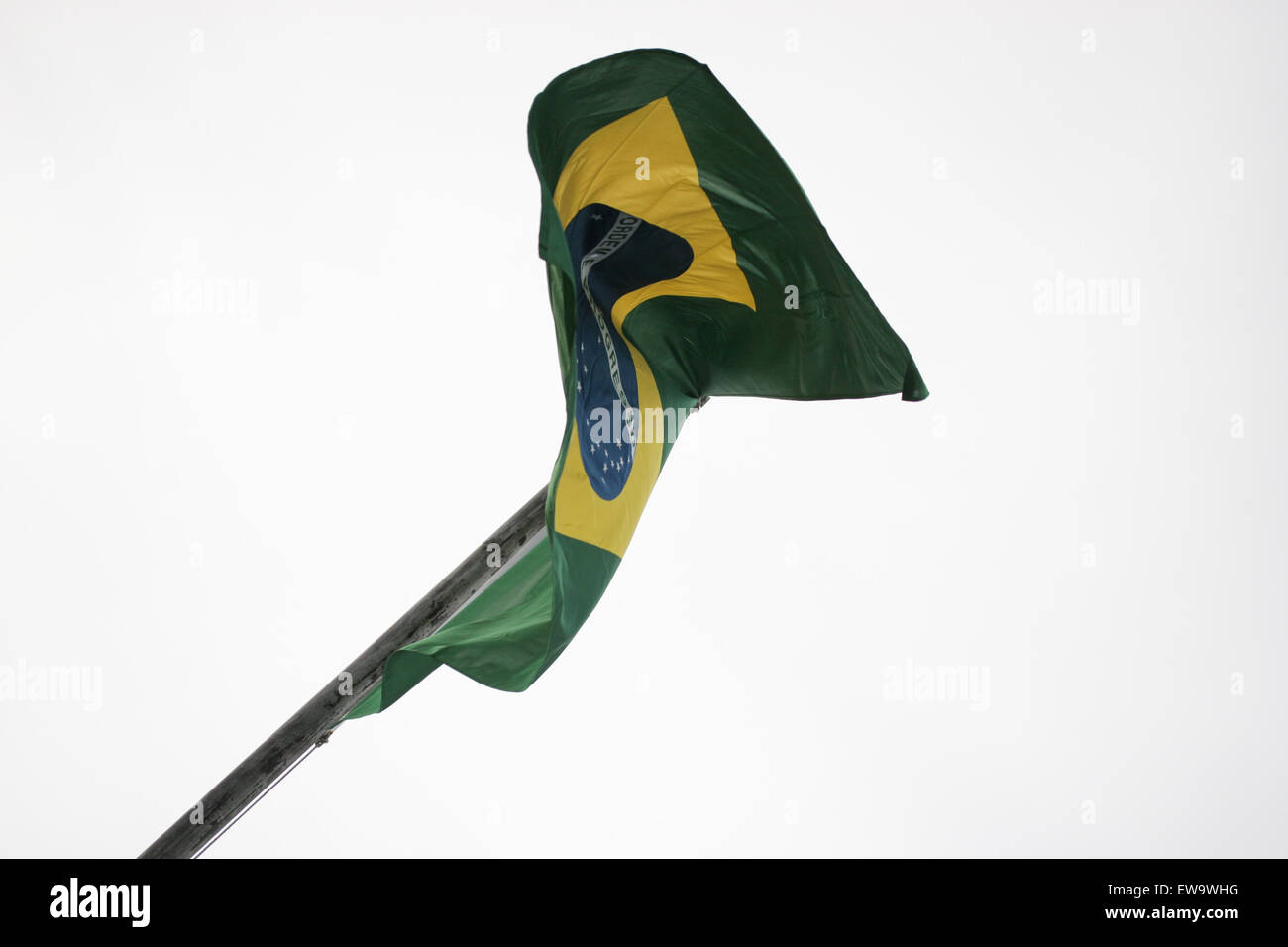 Brazilian flag waving on pole on white background Stock Photo - Alamy