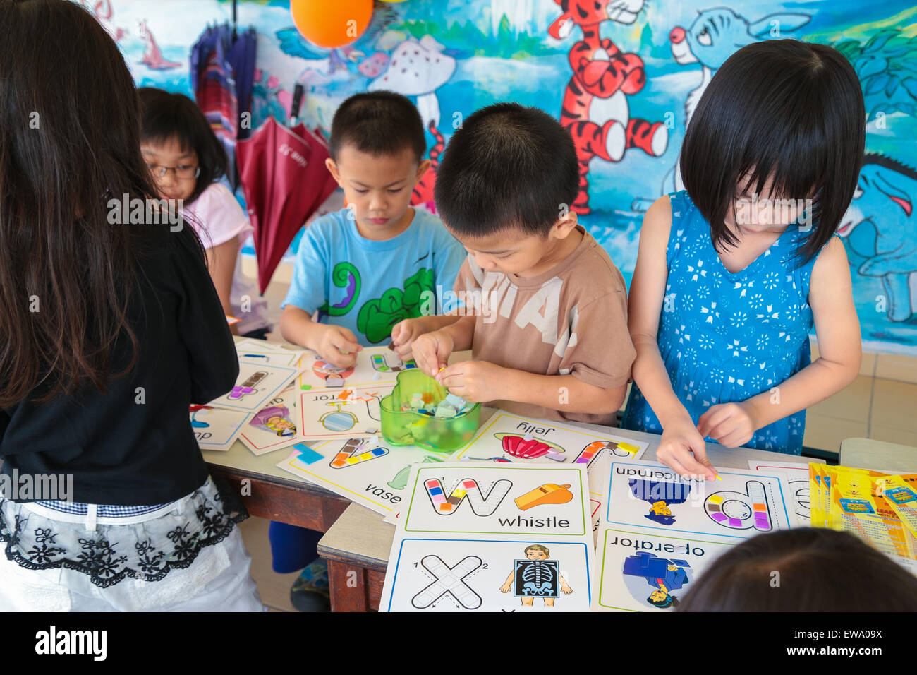 Children playing with word learning cardboard Stock Photo - Alamy