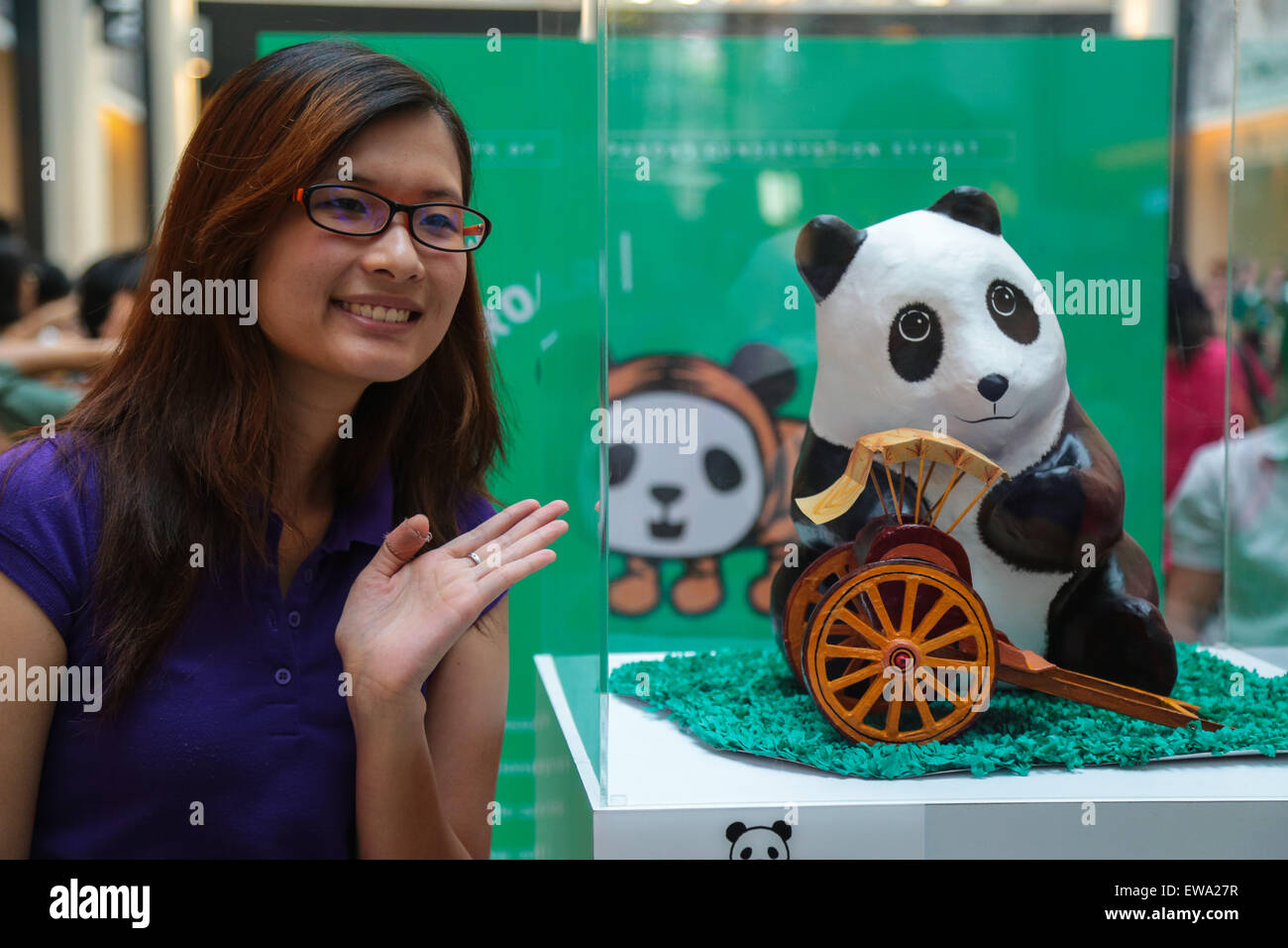 Young lady posing beside a mache panda with trishaw at 1600 Pandas ...