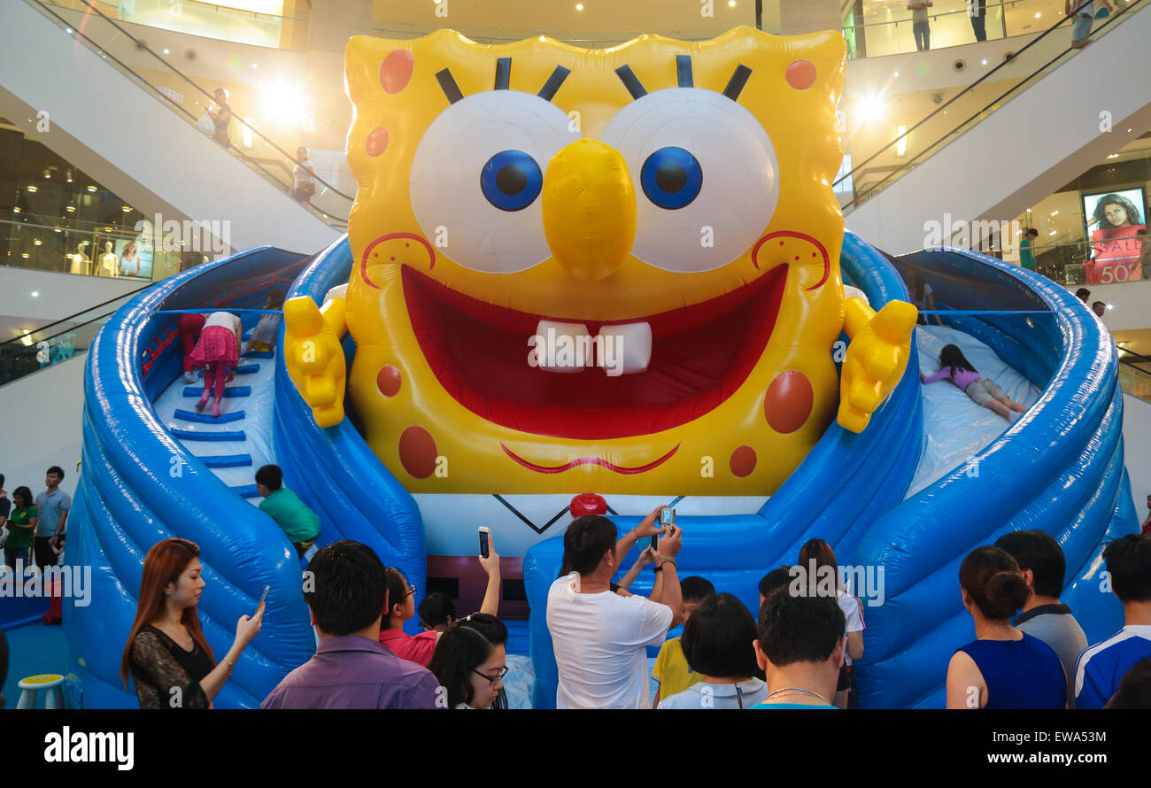 Parents in front the inflatable Spongebob slide at the Spongebob ...
