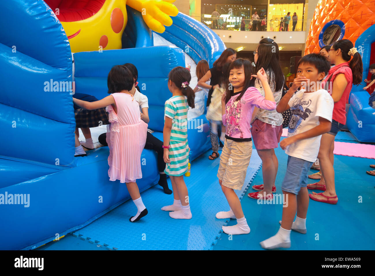 Excited children waiting at the inflatable Spongebob slide at the ...