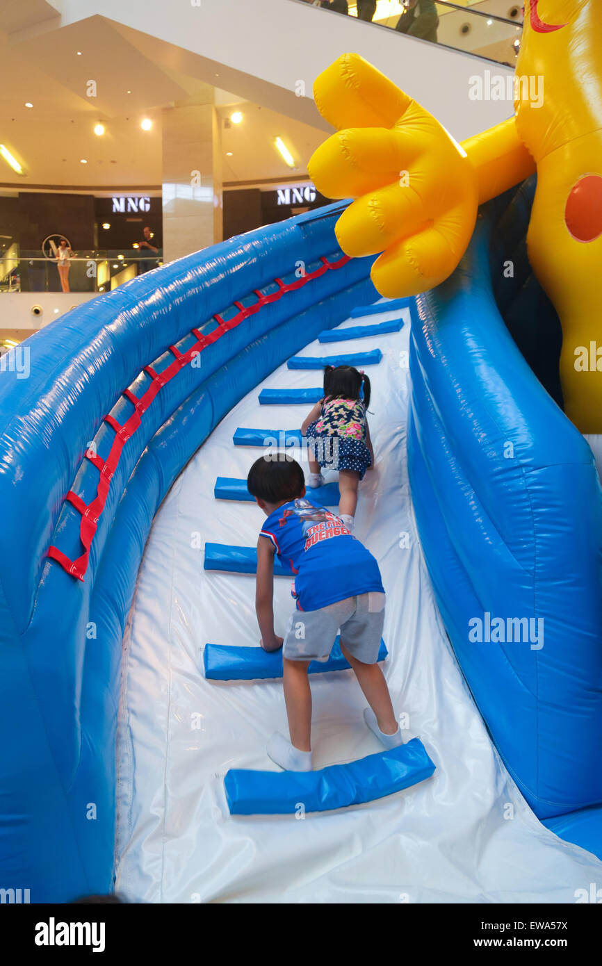 Children playing the inflatable Spongebob slide at the Spongebob ...