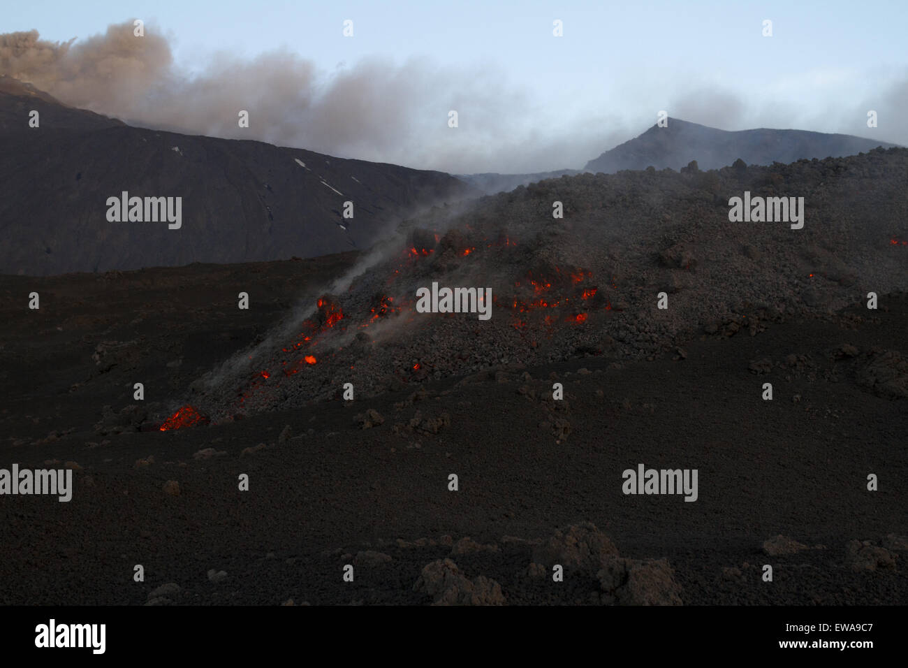 Volcano eruption with lava flow at dawn Stock Photo - Alamy