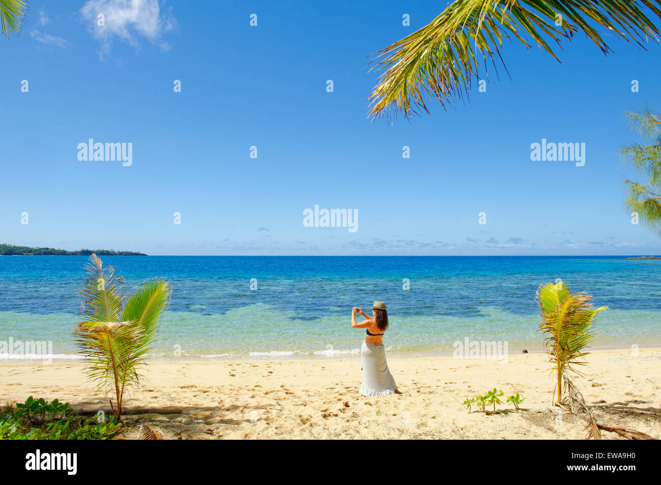 Woman Photographing a tropical beach, Drawaqa Island, Yasawa island ...