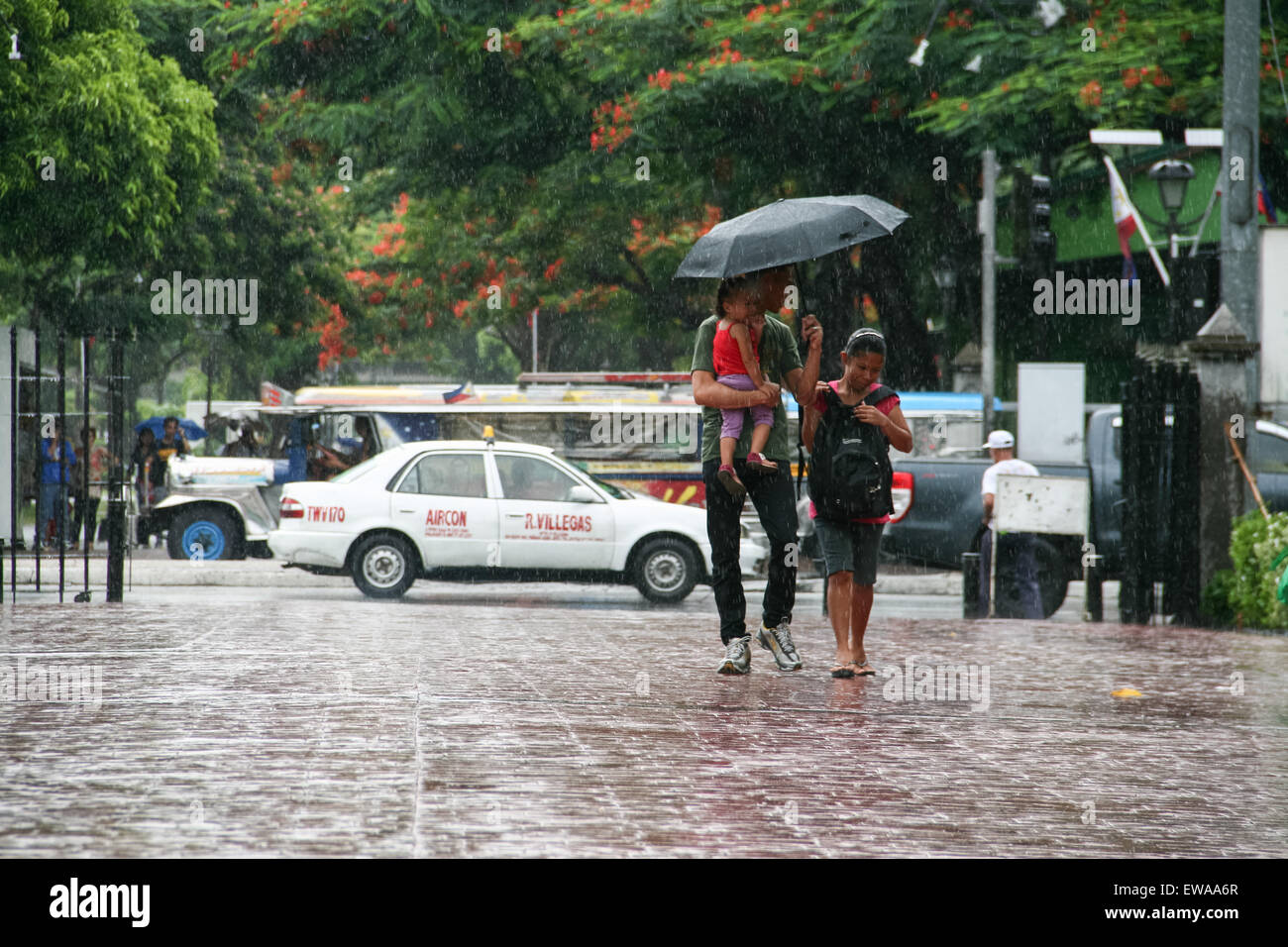 Manila, Philippines. 21st June, 2015. A family walks along Rizal Park ...